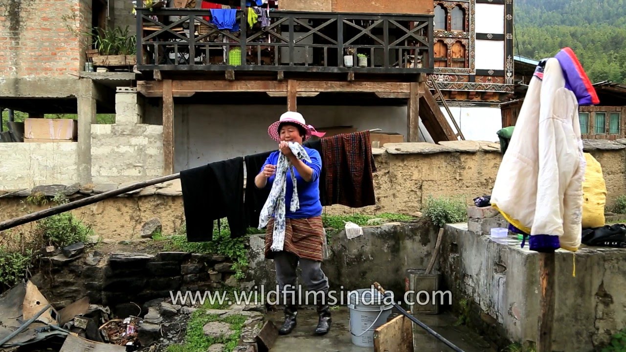 Woman does laundry at Ngoba village in Bhutan - YouTube