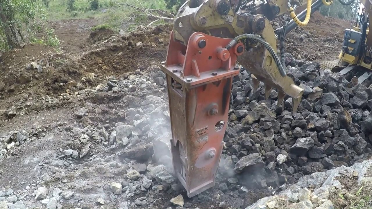 Hammering rock with an excavator - YouTube