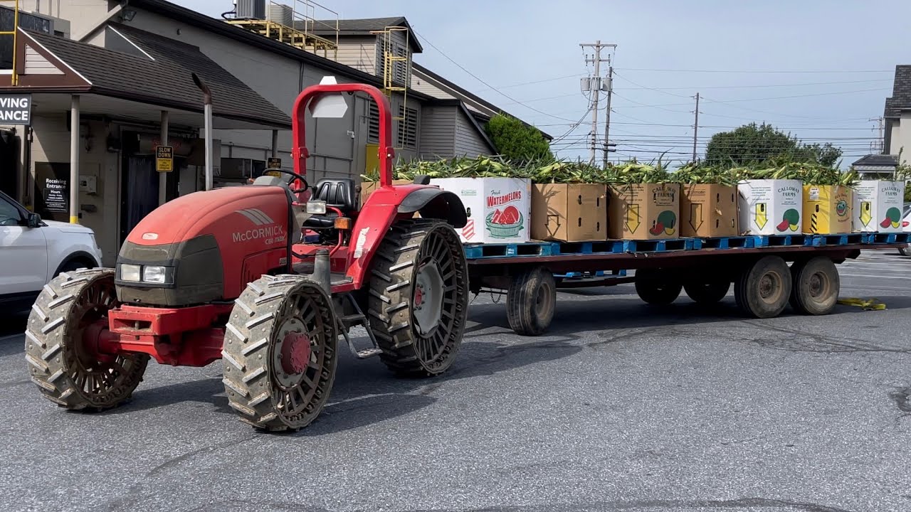 Mennonite Corn Delivery on tractor with metal wheels - YouTube