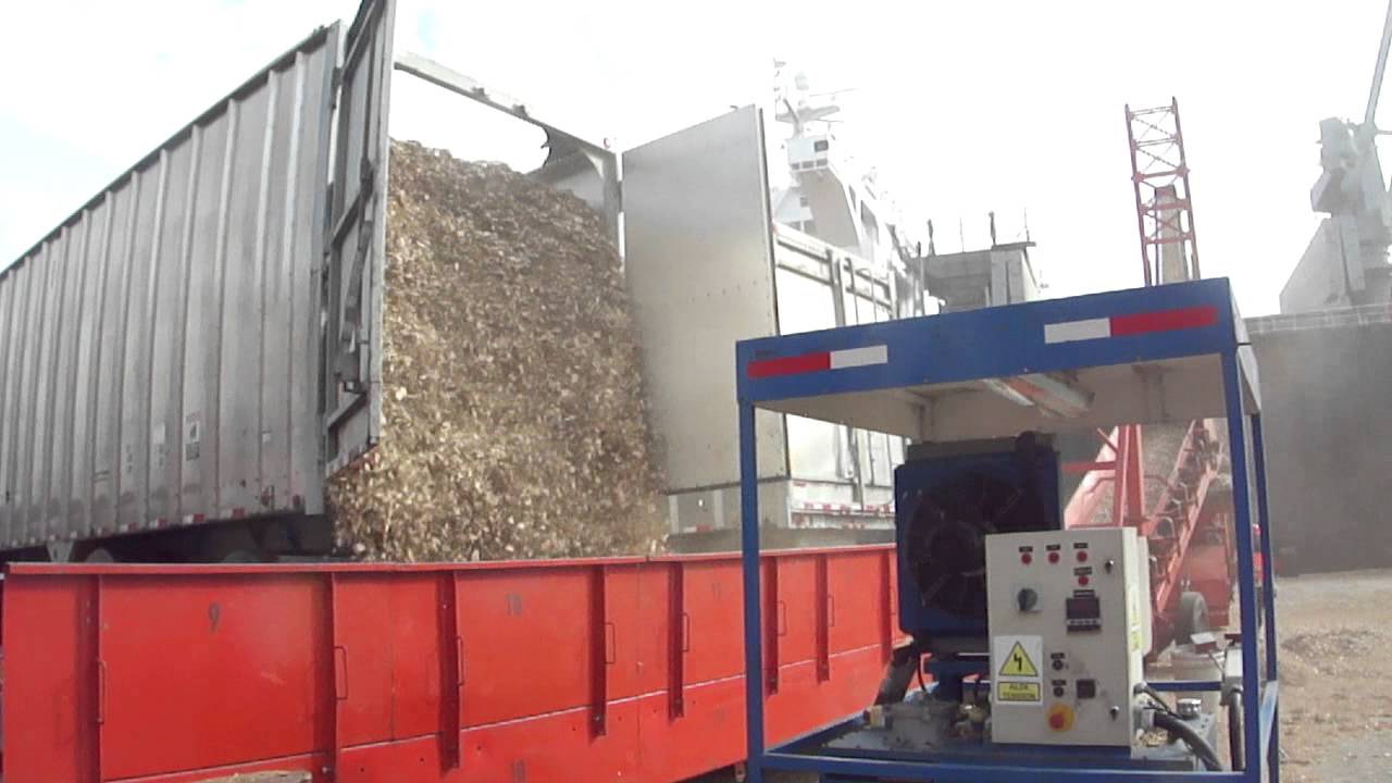 wood chip carrier loaded from self discharging trucks - YouTube