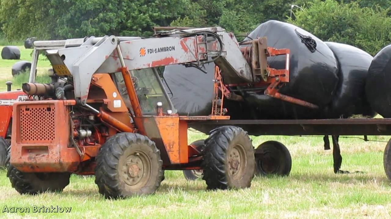 Silage - Carting and Stacking Round Bales - YouTube