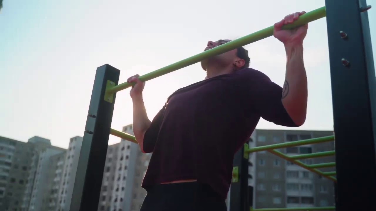 A Man using an Outdoor Monkey Bar do pull -up Exercise - YouTube