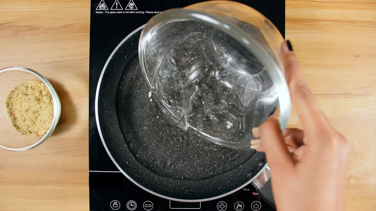 A lady putting water in a frying pan for boiling | Indian Stock Footage ...
