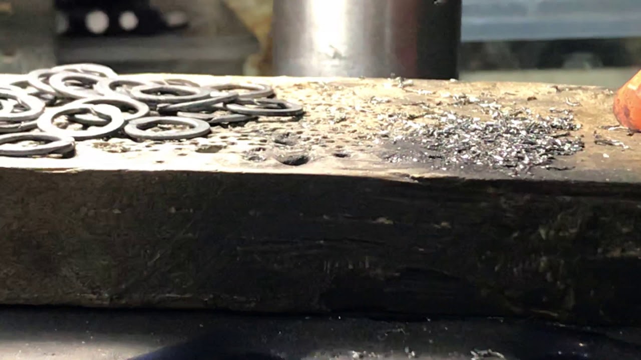 the process of drilling rings for armor - YouTube