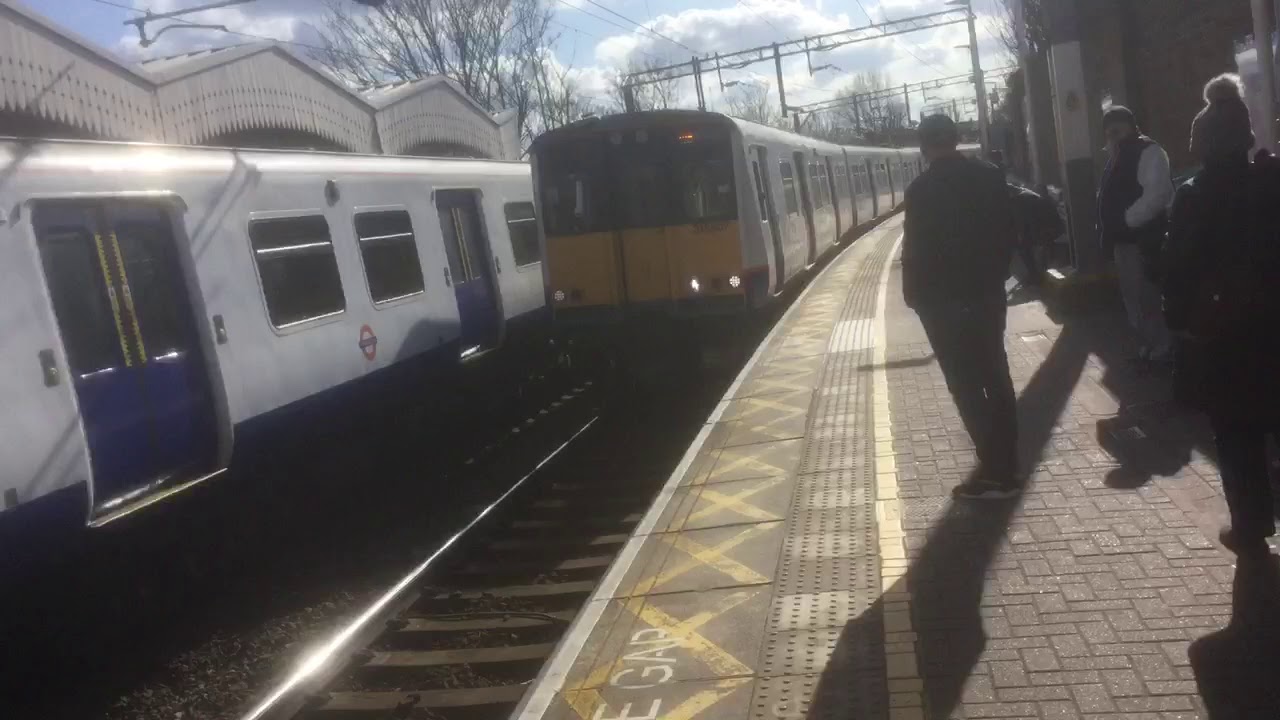 2 London overground trains class 315 arriving and departing at Bruce ...