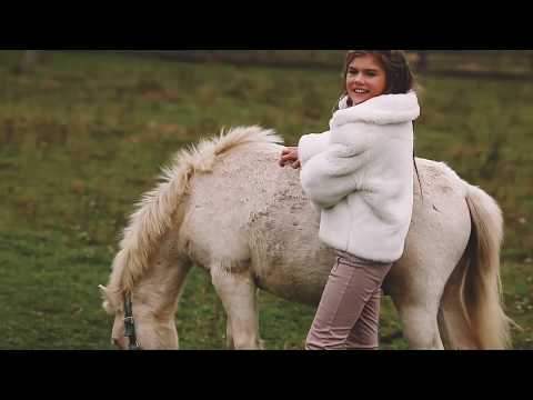 A Young Model Girl On The Farm With Sheeps And Pony
