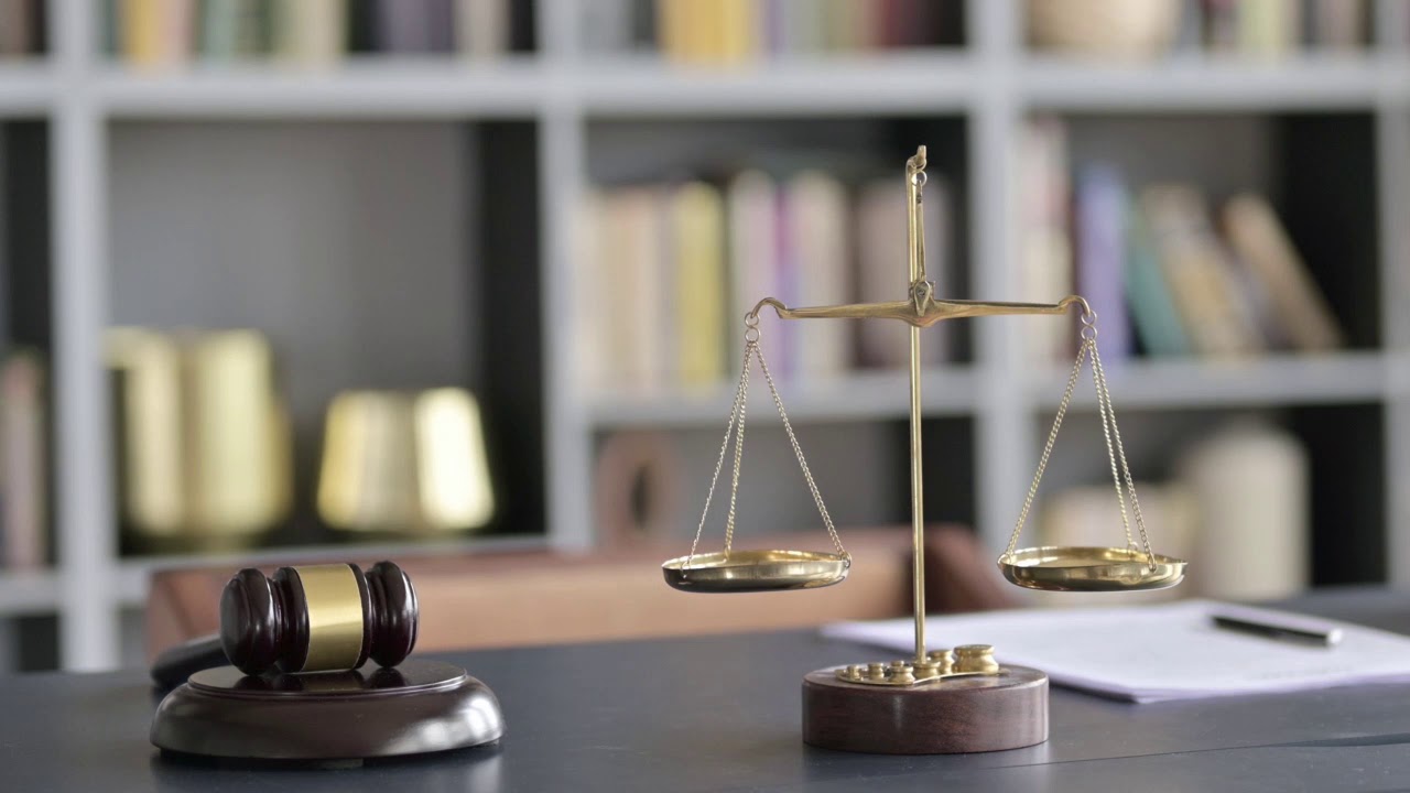 balance scale and gravel on court room table - YouTube