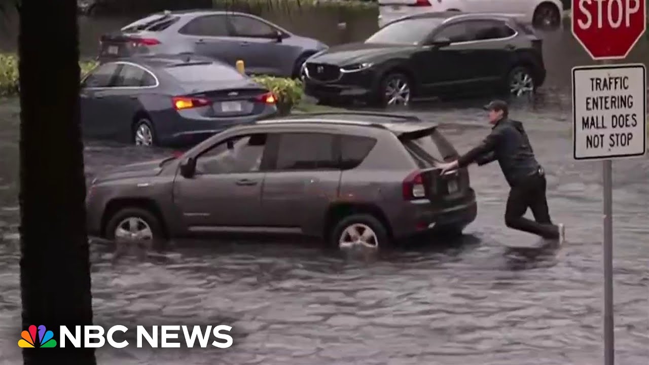 WATCH: NBC reporter pushes car out of water as severe flooding hits ...