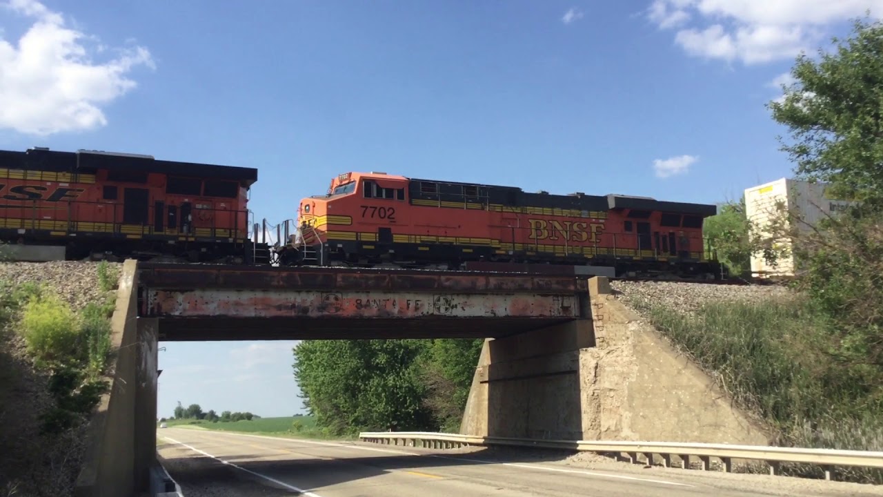 BNSF 6036 (ES44AC) leads a westbound BNSF stack train over Route 251 ...