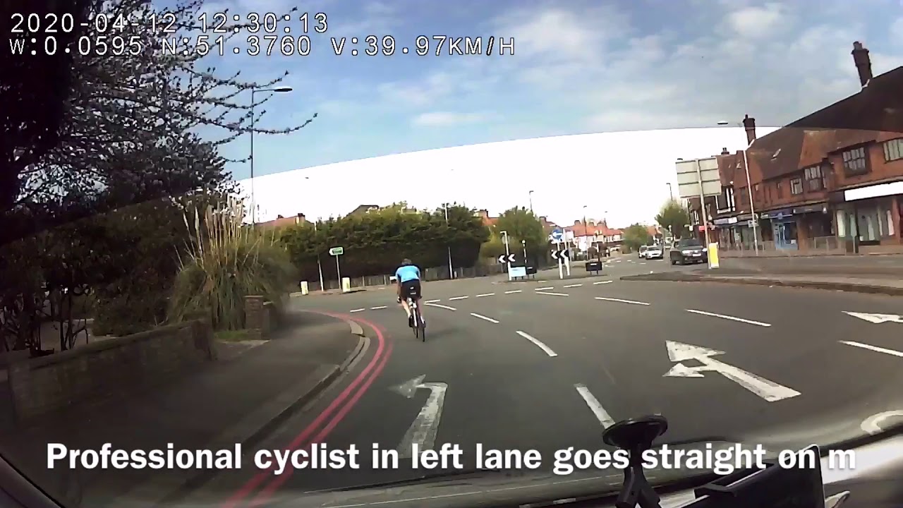 Cyclist in left hand lane goes straight on across a roundabout - YouTube