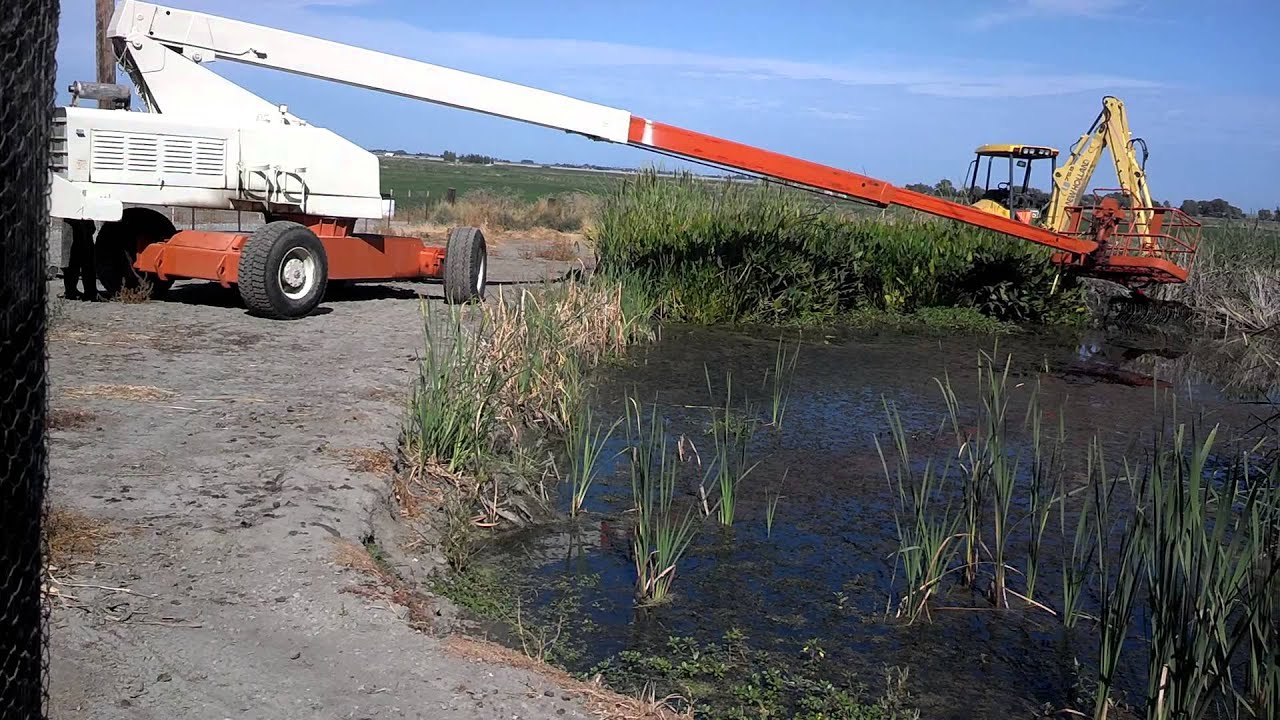 01 13 year old using manlift landscape rake to clean pond - YouTube