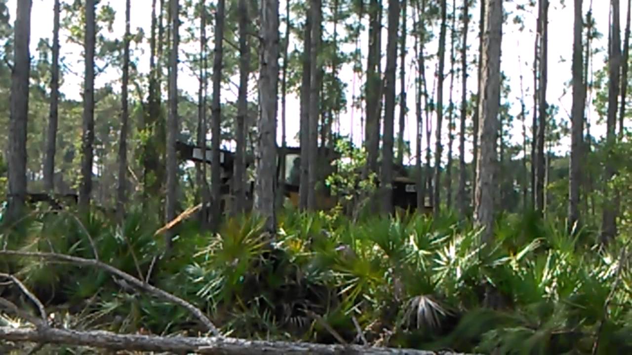 Log skidder pulling a double drum roller chopper - YouTube