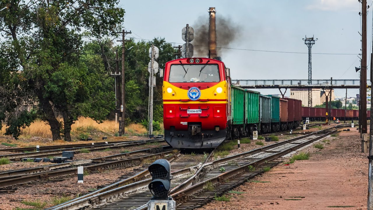 Diesel locomotive TE33A 0278 with a freight train departs from the ...
