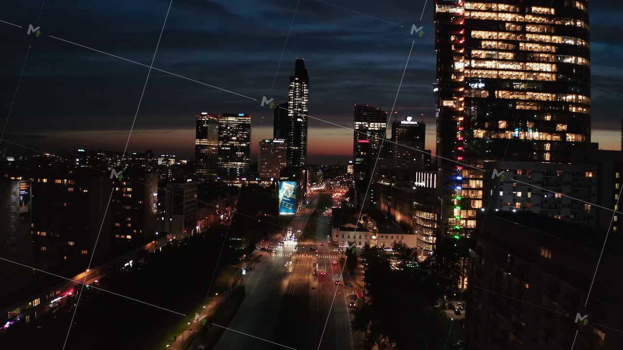 Night city scene, High rise illuminated buildings along wide street ...