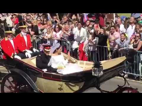 Prince harry and Meghan market pass by in carriage after getting married