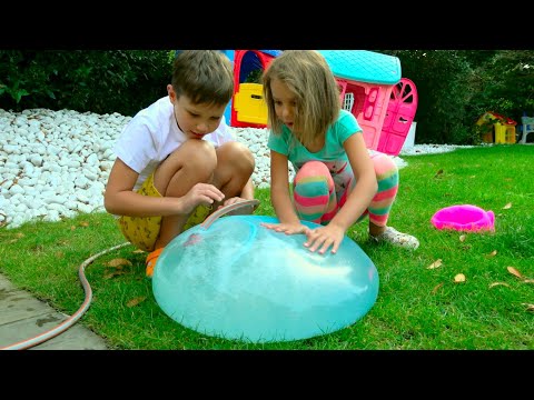 Max and Katy playing with outdoor activity toys