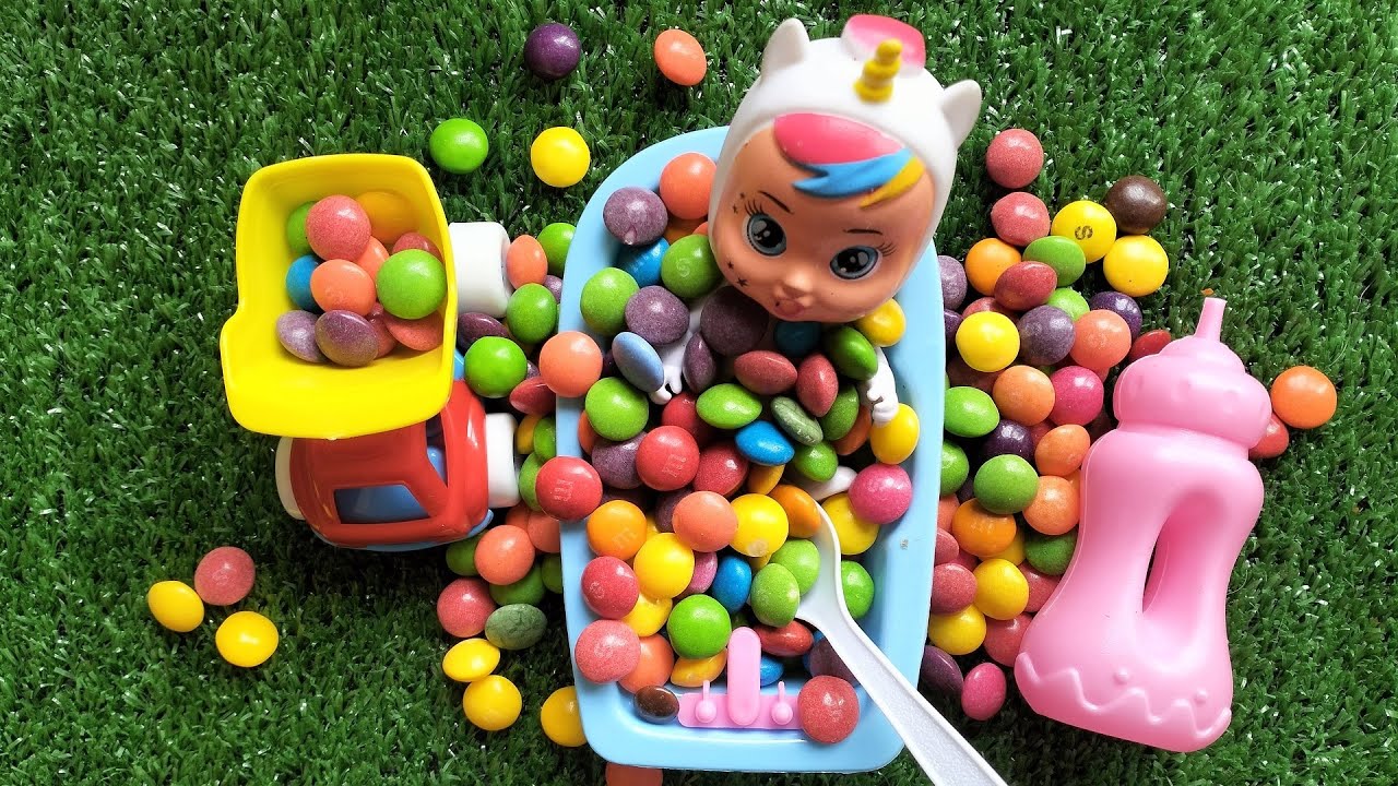Satisfying video of rainbow mixing candies in a blue tub on a truck ...
