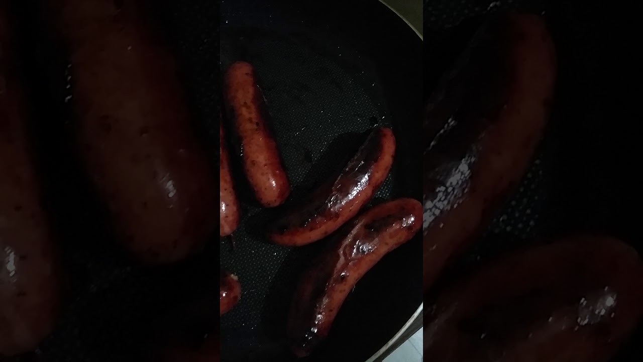 Sausages sizzling in the frying pan. - YouTube