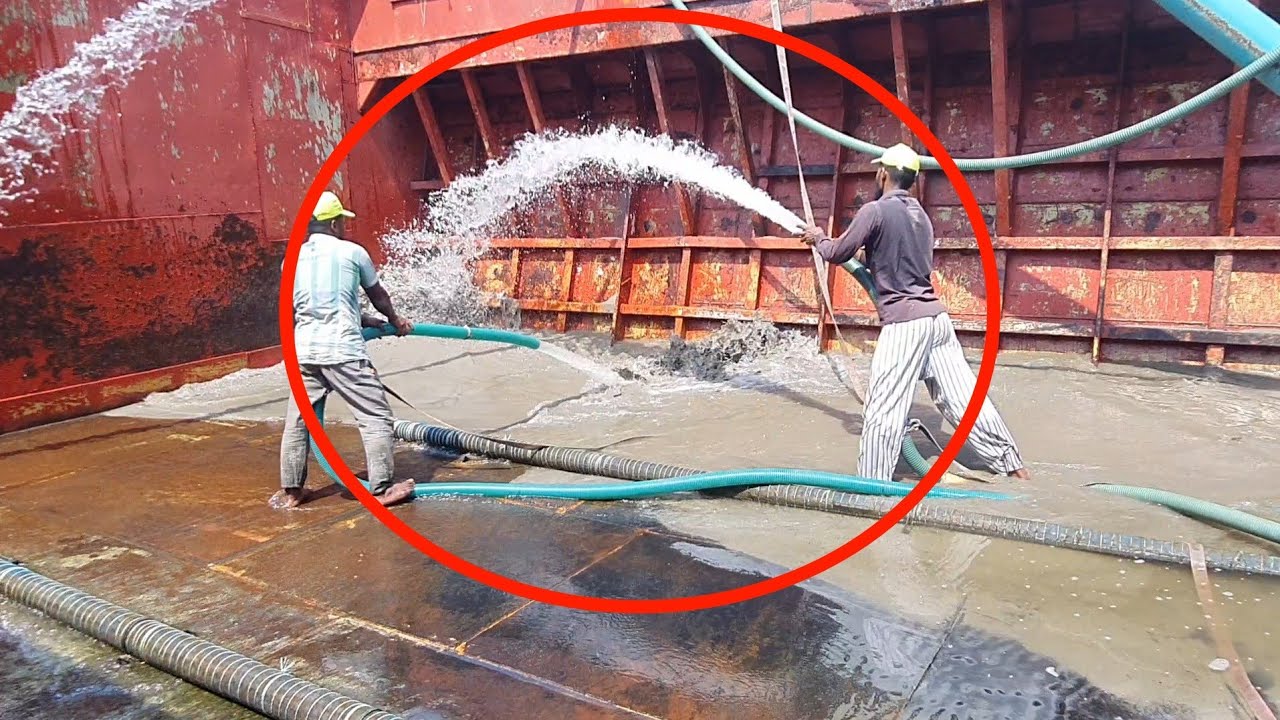 Sand is being unloaded from large ships with powerful dredger machines ...