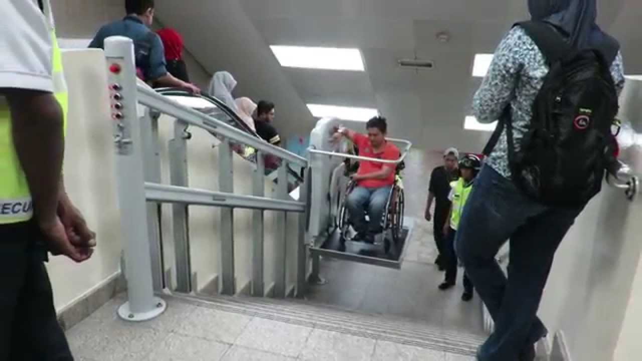 Wheelchair user on stair lift - YouTube