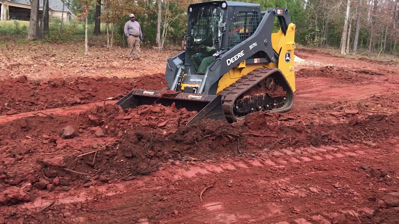 John Deere 317G Cutting A Swale In Hard Clay Part 2 - YouTube