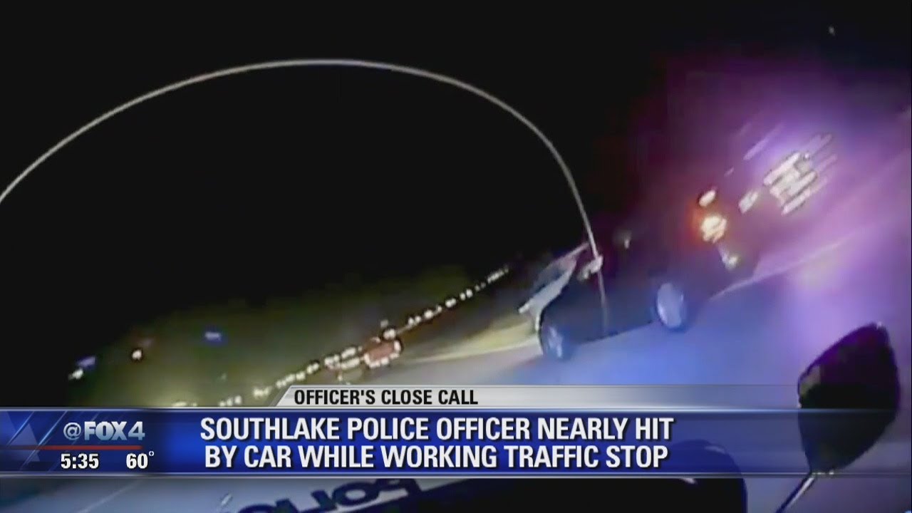 Police officer nearly hit by car while working traffic stop - YouTube