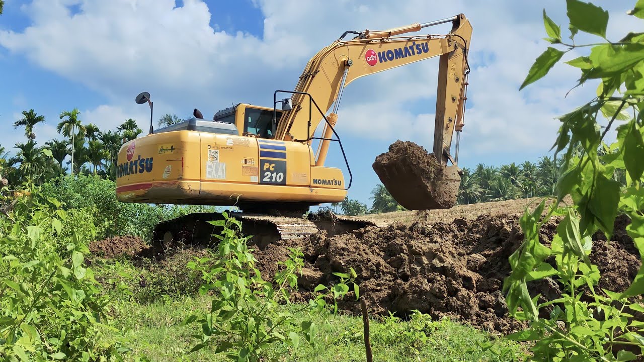 Komatsu PC210 Heavy Equipment Traversing Forests for International Toll ...