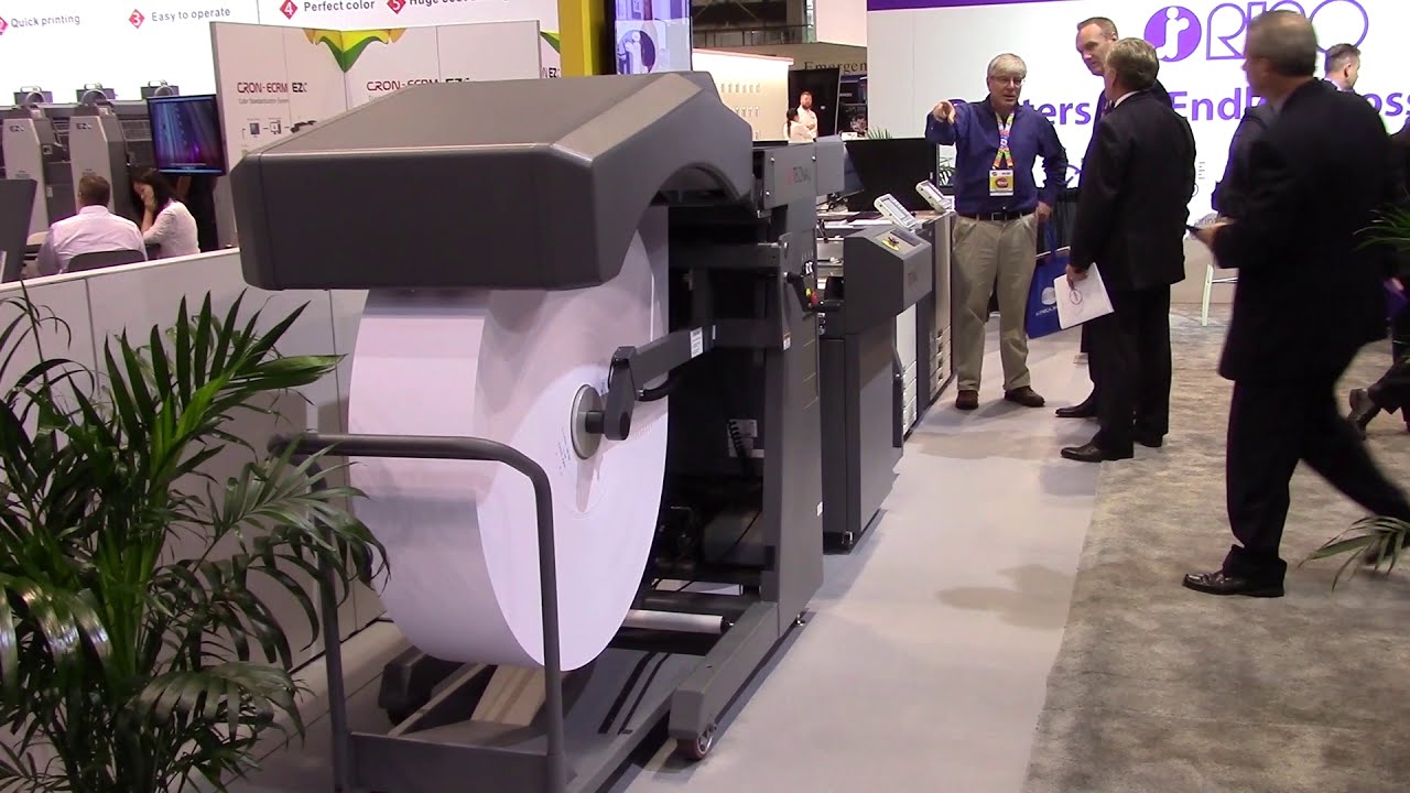 Tecnau Roll Feeder running on a RISO T2 - YouTube
