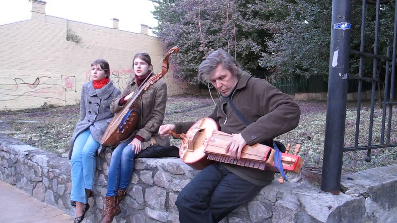 Street ethno-musicians playing Wheel fiddle ("Hurdy-gurdy", folk string ...