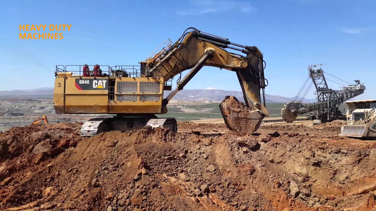 CATERPILLAR 6040 EXCAVATOR LOADING TEREX TR100 WITH 2 PASES - YouTube