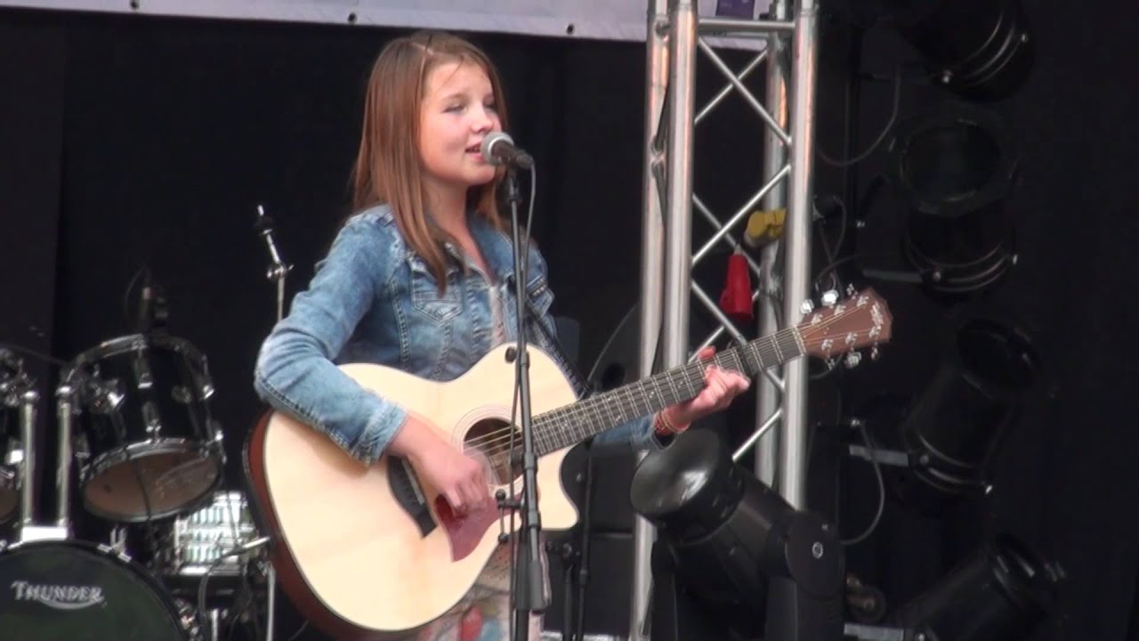 Nikki's playing some acoustic guitar covers live on stage at ...
