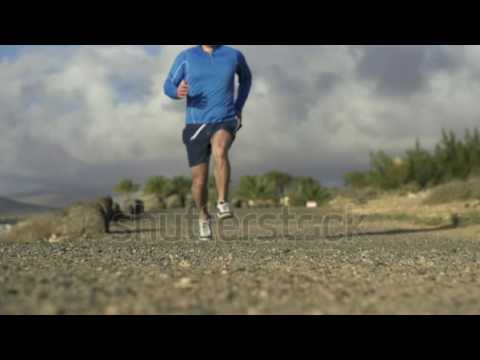 stock footage man jogging in on dirt track super slow motion shot at ...