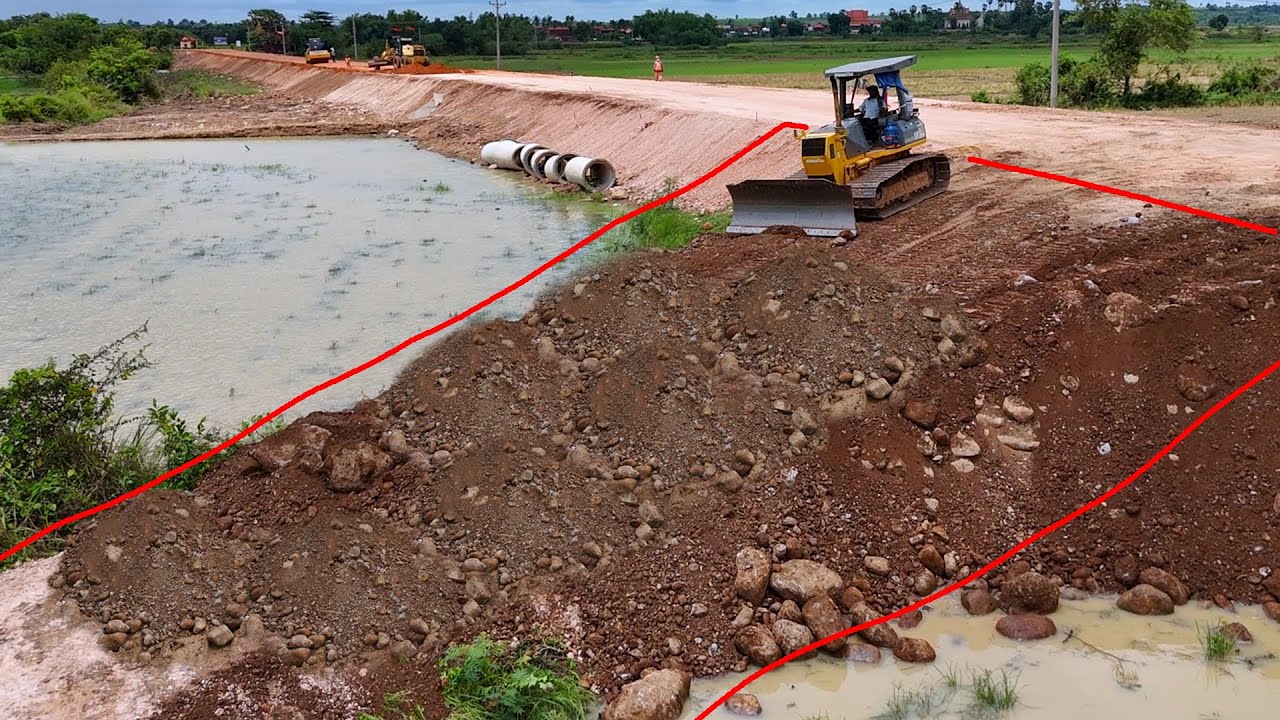 Excellent skillful dozer operator pushing dirt rock to build the road ...