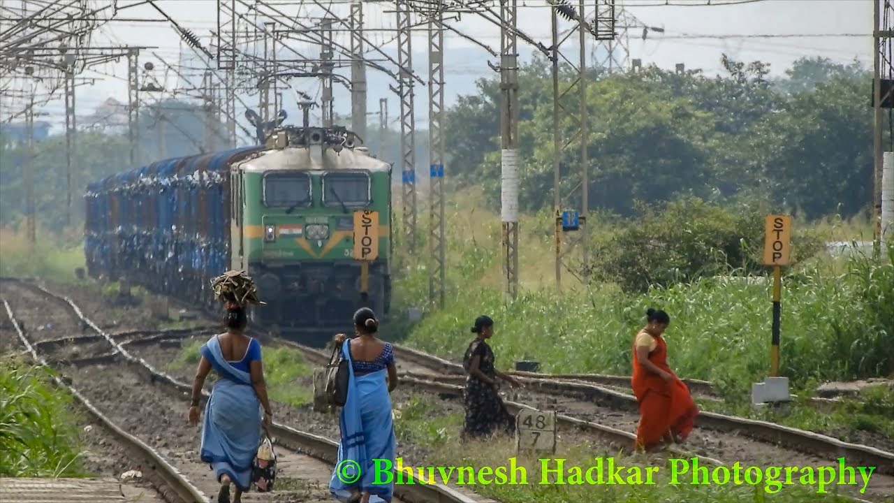 People Crossing Railway Track Without Watching Oncoming Freight Train ...