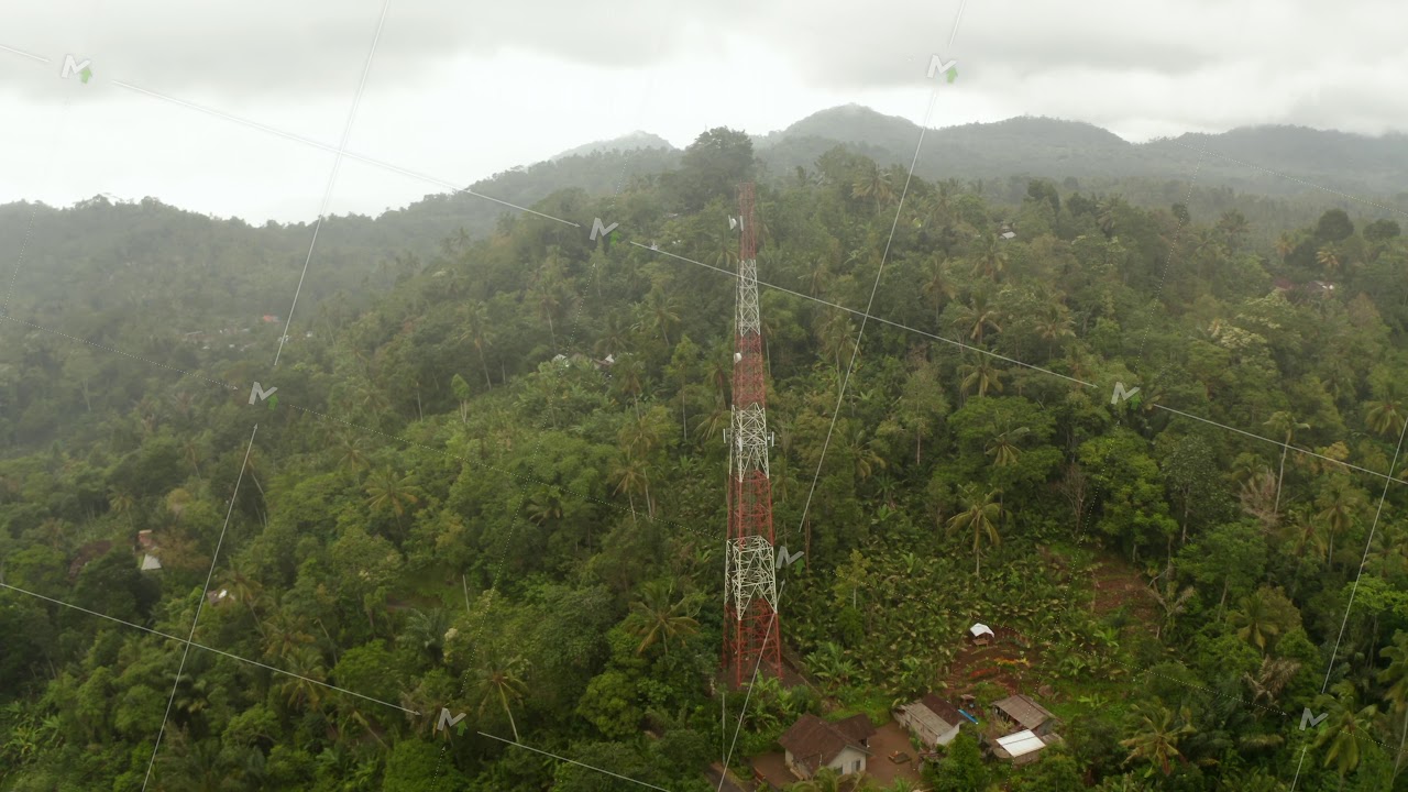 Close up aerial view of broadcast radio tower in the jungle. Wireless ...