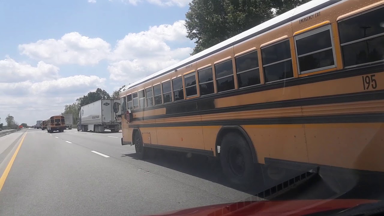 Buses w/ blacked-out windows and labels traveling just south of London ...