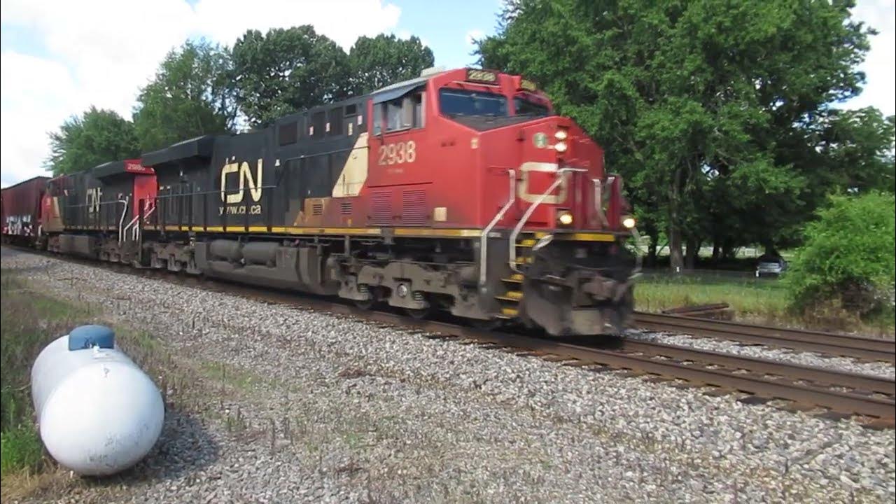 CN 2938, 2988 running an Eastbound freight train with 18 CN ballast hoppers past Vicksburg, MI ...