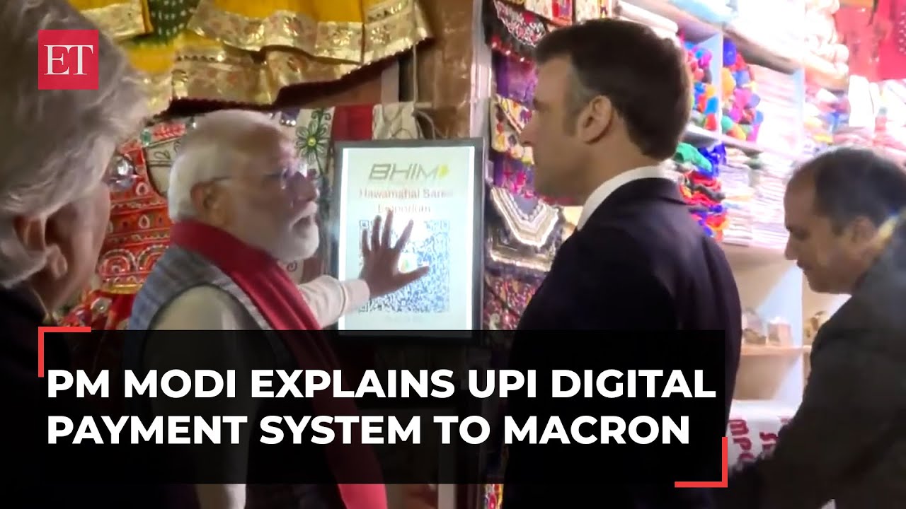 PM Modi explains UPI system to French President Macron outside local ...