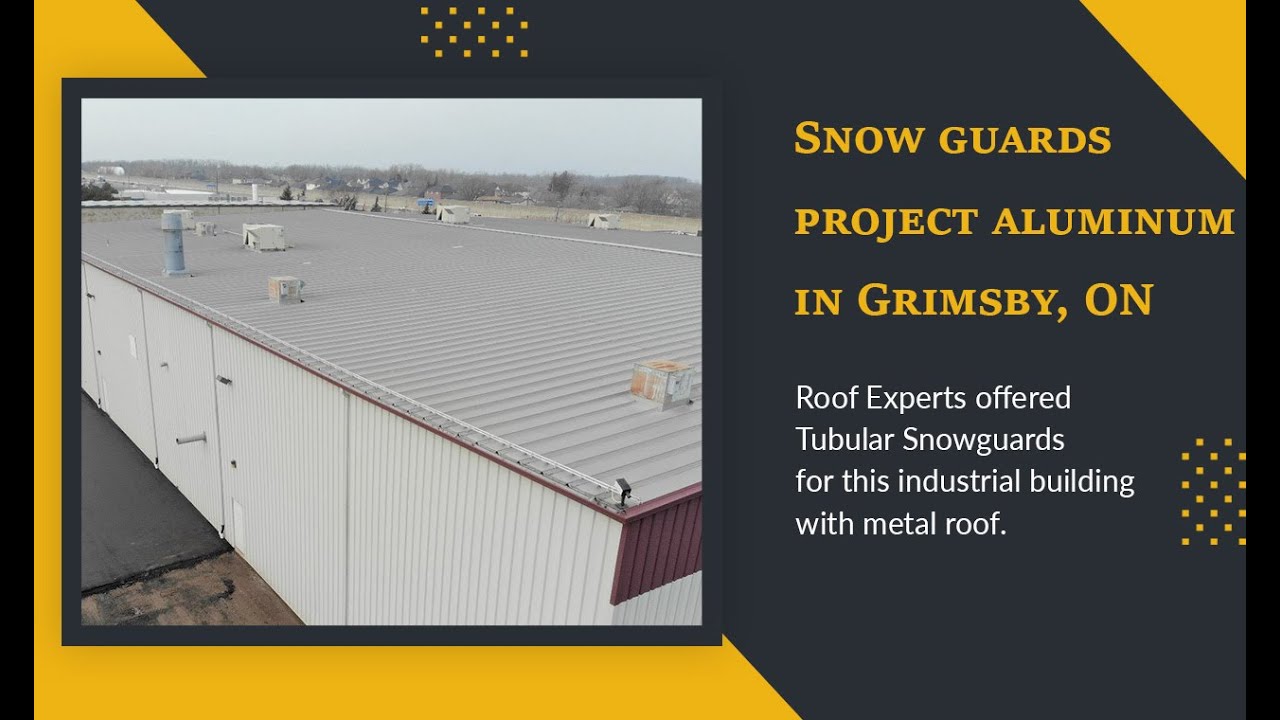 Snow guards on metal roof industial building in Grimsby, Ontario. Snow ...