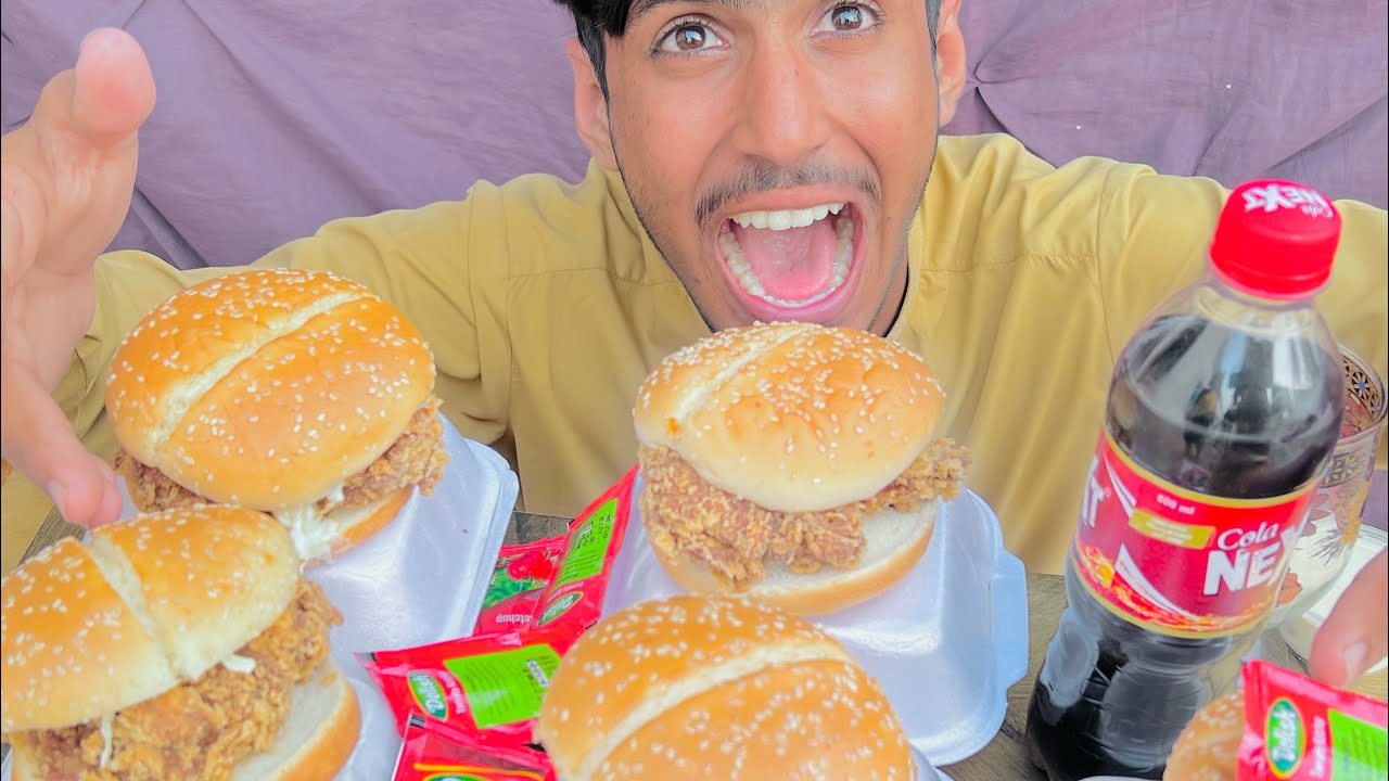 EATING FAST FOOD ZINGER BURGER WITH KETCHUP DIP SAUCE AND COLD DRINK ...