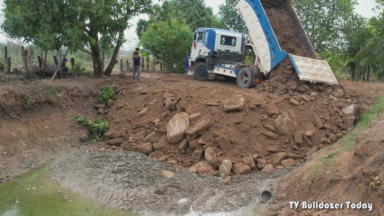 Dump Truck Working Pour The Soil Into The Mud Pit - Mini Bulldozer Push ...