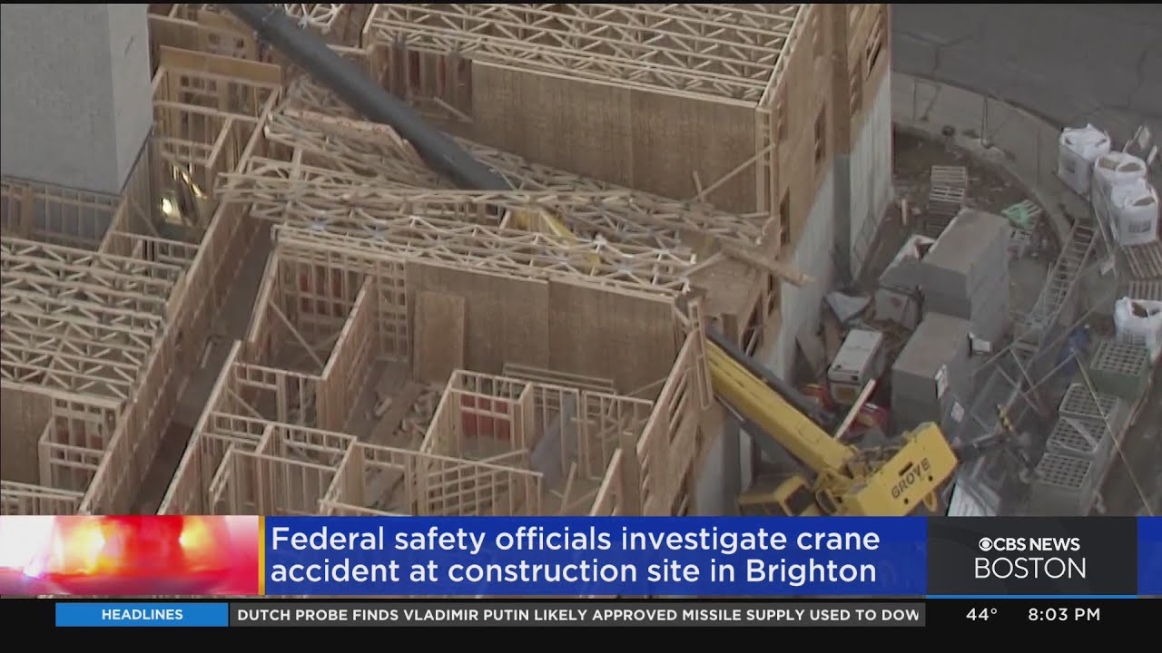 Crane falls onto building under construction in Brighton - YouTube