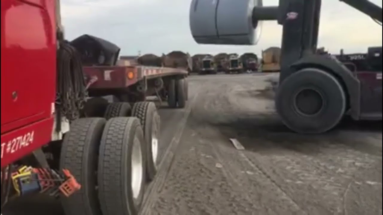 Semi trucks | Unloading a scrapped steel coil from a flatbed - YouTube