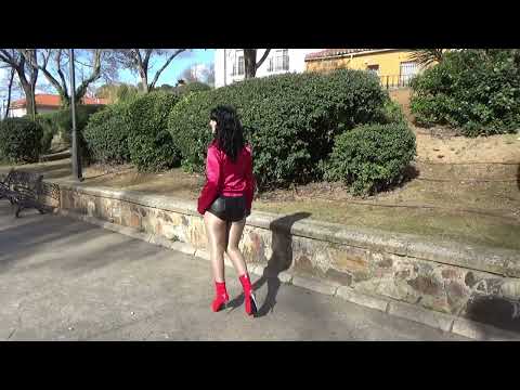 Victoria Devil. Walking outfit black leather mini shorts, red blouse and heeled ankle boots