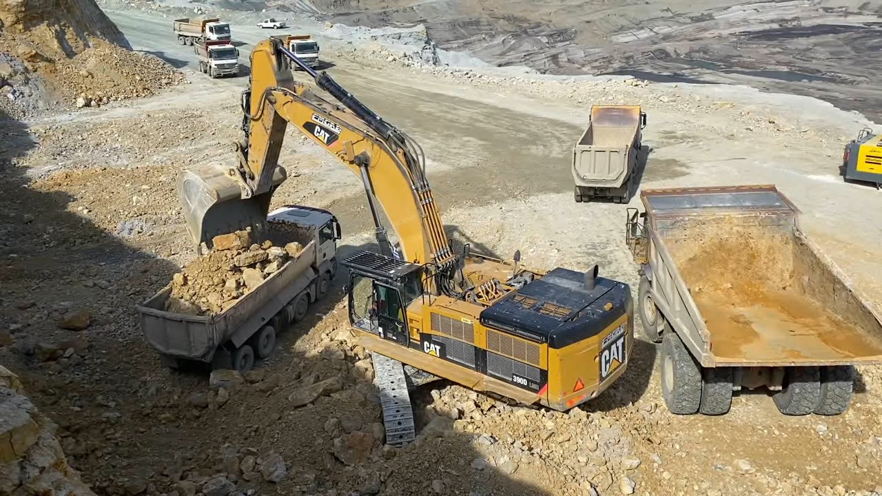 Caterpillar 390D Excavator Loading Caterpillar 775E Dumper And Trucks ...