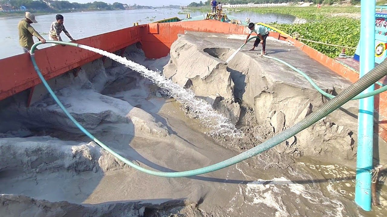 Unload sand from big ship by powerful drager machine and powerful water ...