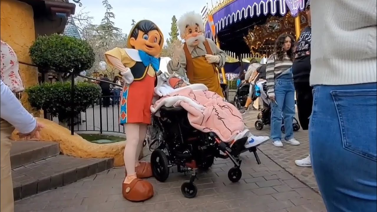 Pinocchio and Geppetto with a sleeping paraplegic kid in Disneyland on ...
