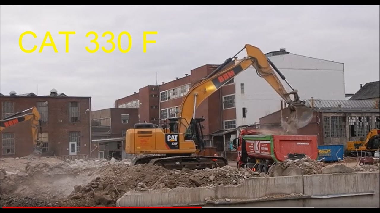 Excavator CAT 330F loads truck with debris from demolition - YouTube