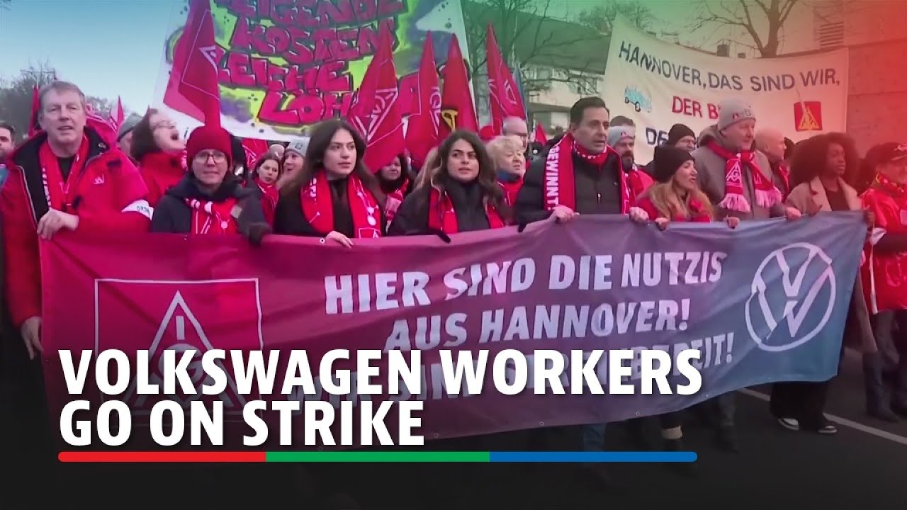 Faced with wage cuts and plant closures, angry VW workers across ...
