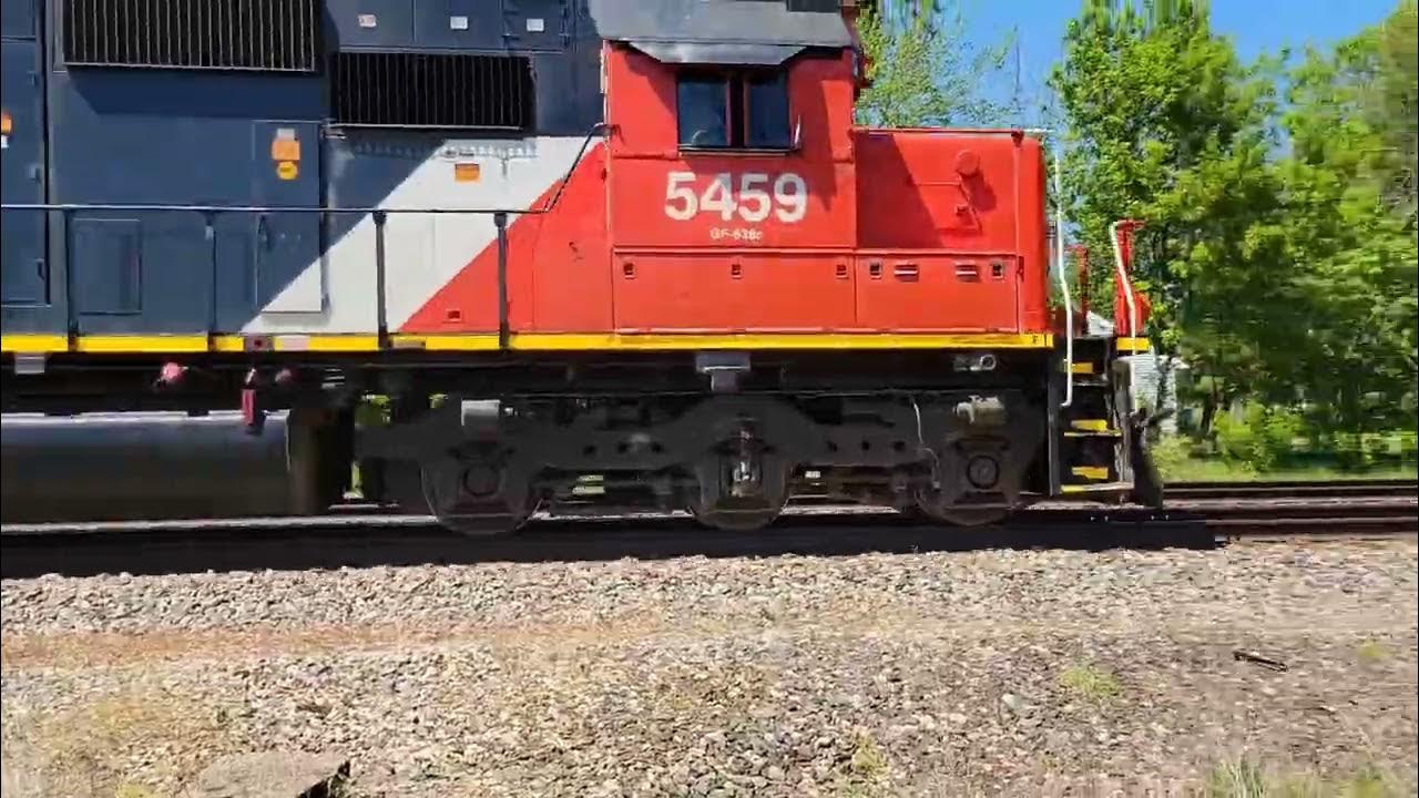 CN 5459, 5469 Eastbound freight train with GTW blue box car, TTZX TTX opera center beam flat car ...